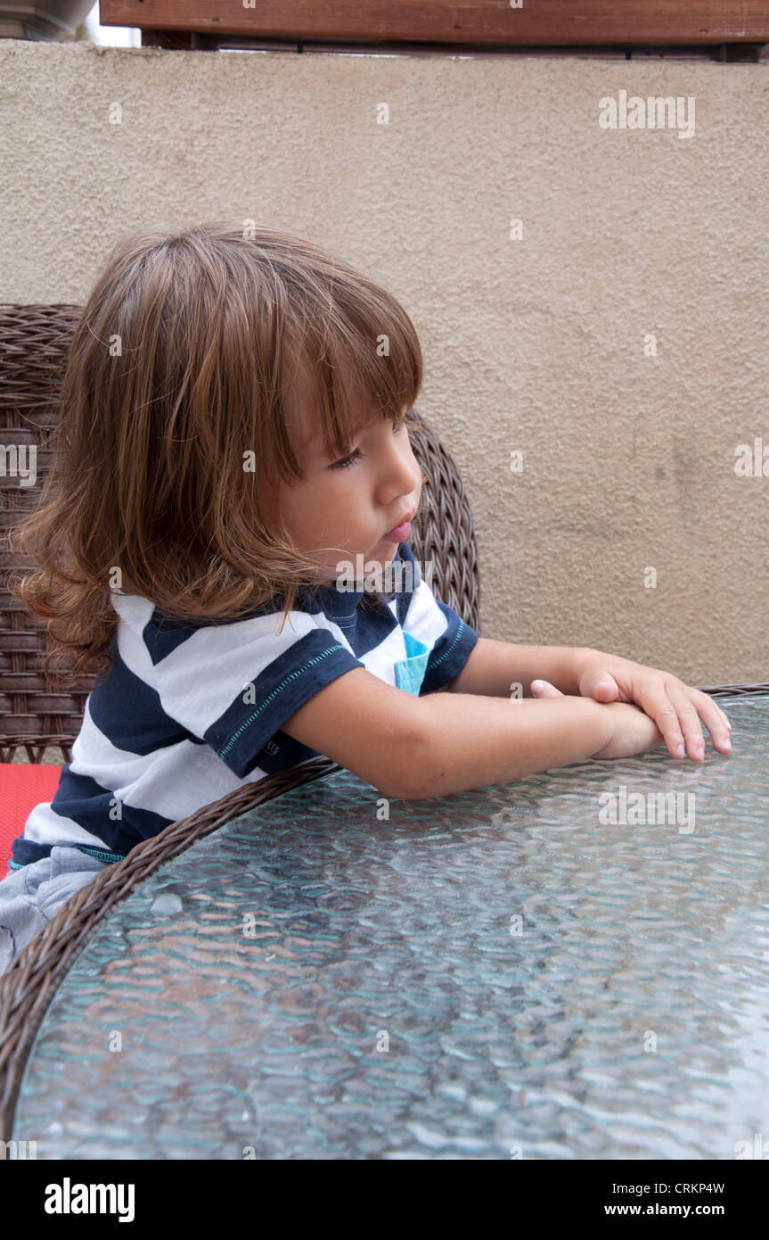 Child playing at table Stock Photo - Alamy