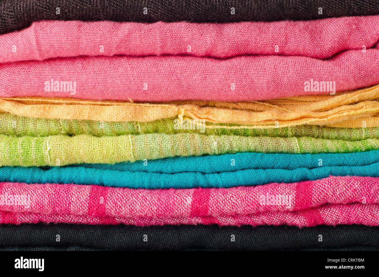 Pile of colorful scarves background Stock Photo - Alamy