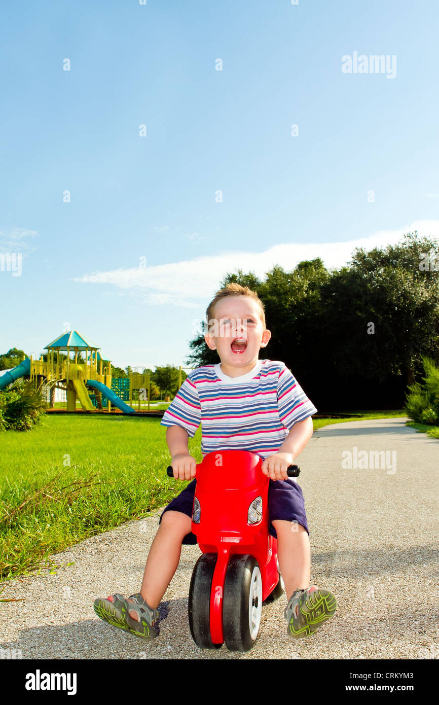 little boys racing on the toy motorbikes Stock Photo - Alamy