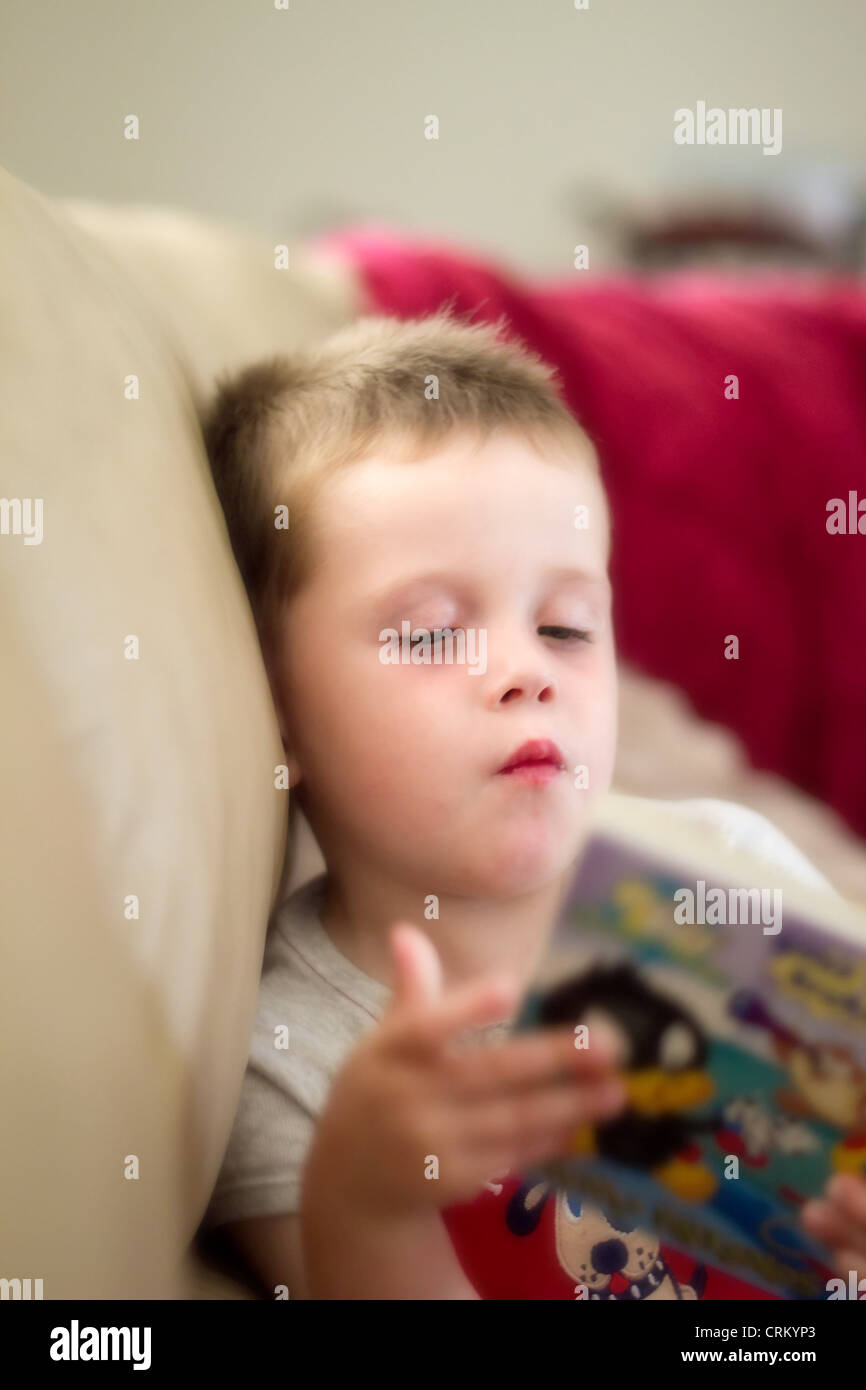little boy reading his bedtime story in the sofa Stock Photo - Alamy