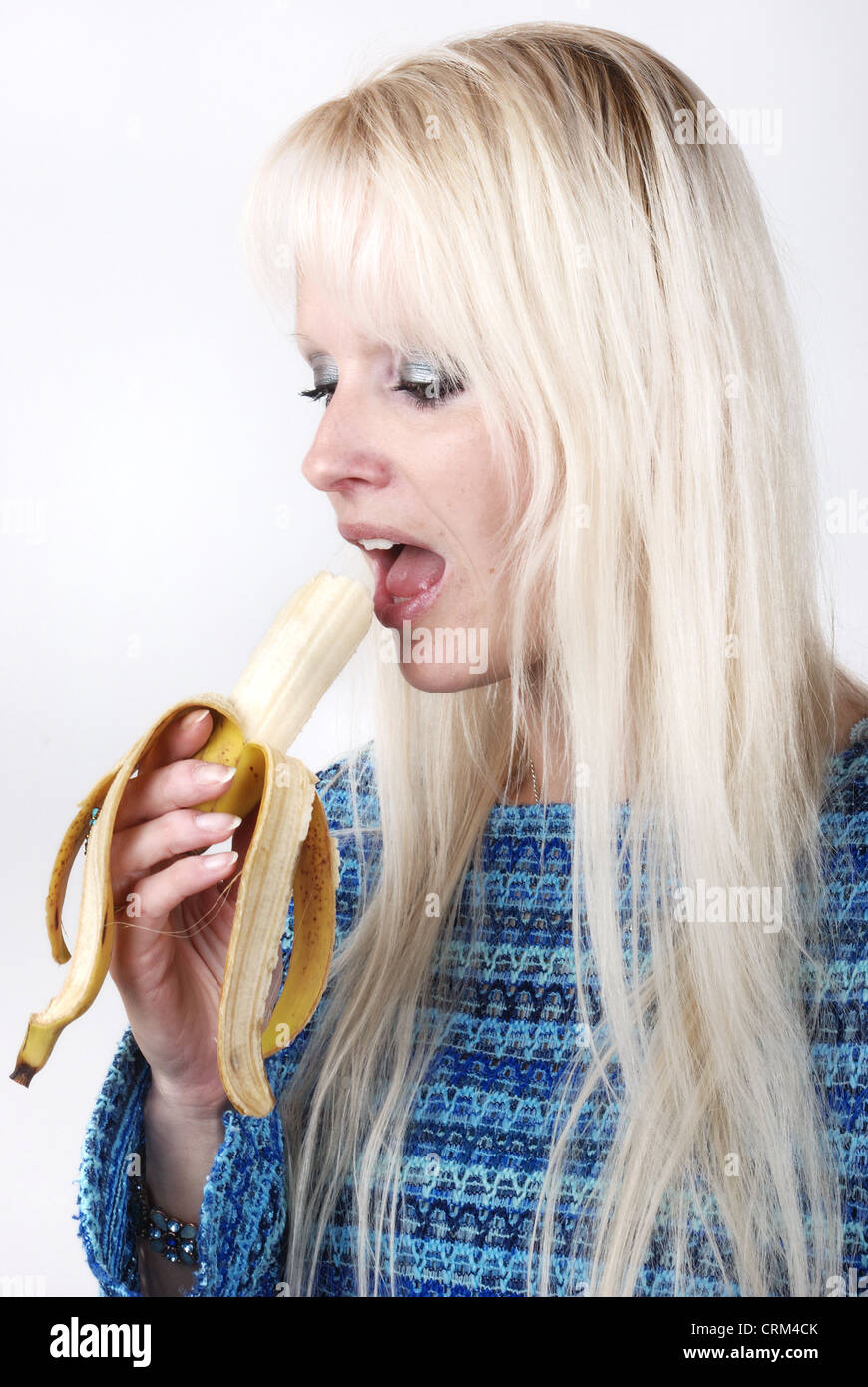 Blond woman eating banana hi-res stock photography and images - Alamy