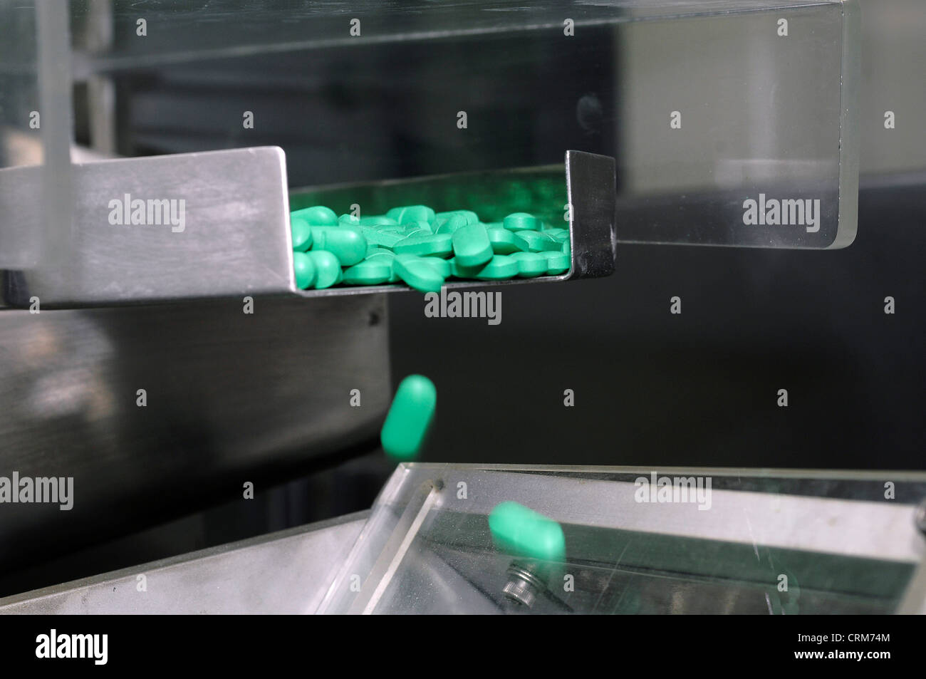 Newly sugar coated tablet pour out of a sorting machine Stock Photo - Alamy