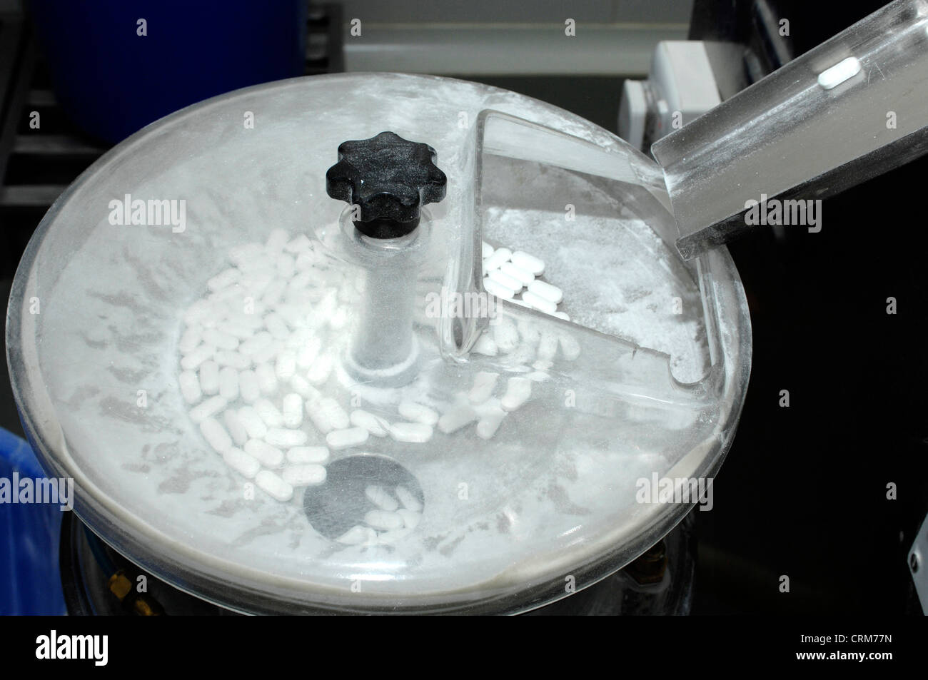 White tablets pour into a sorting device on the production prior to ...