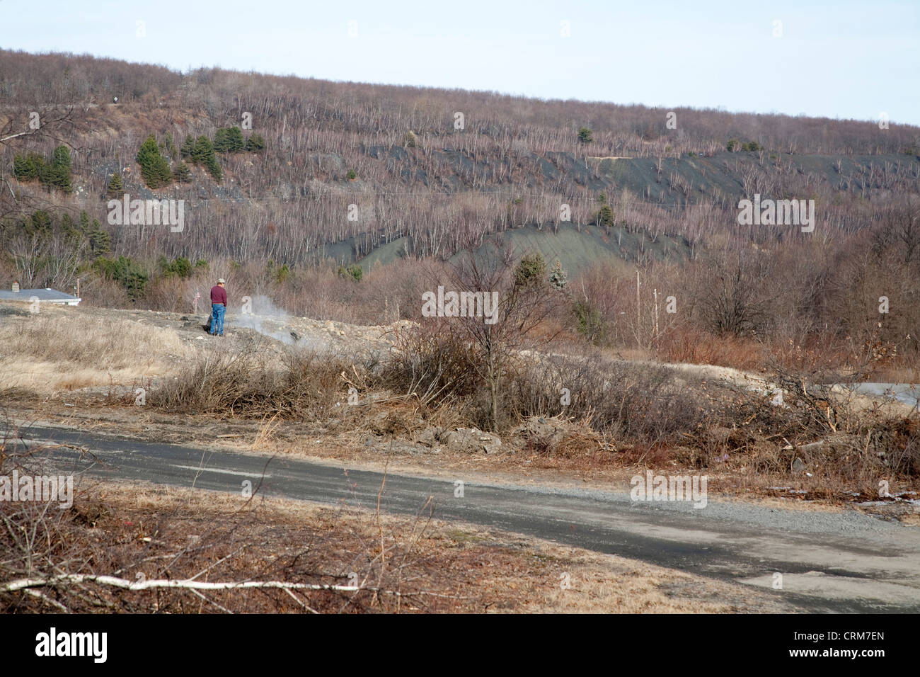 Man looking out over smoke rising from ground of Centralia, Central ...