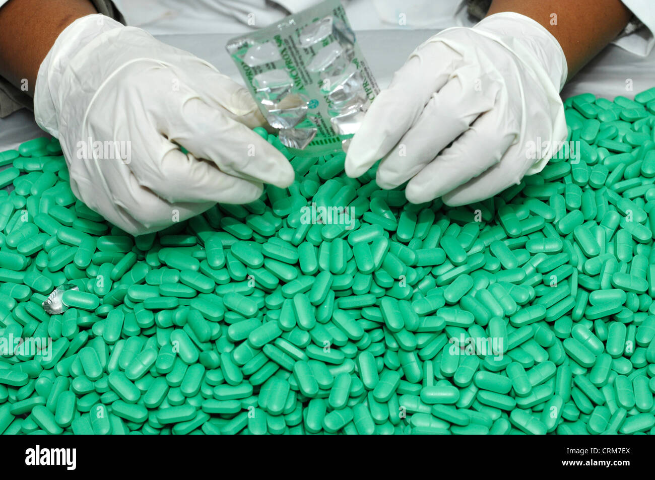 A pharmaceutical technician empties unwanted and defected tablets Stock ...