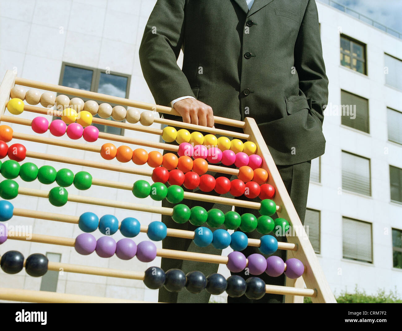 Standing man in a suit based on an abacus Stock Photo - Alamy