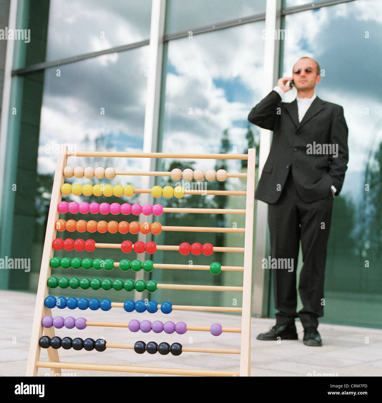 Abacus and a telephony render man in a suit behind Stock Photo - Alamy