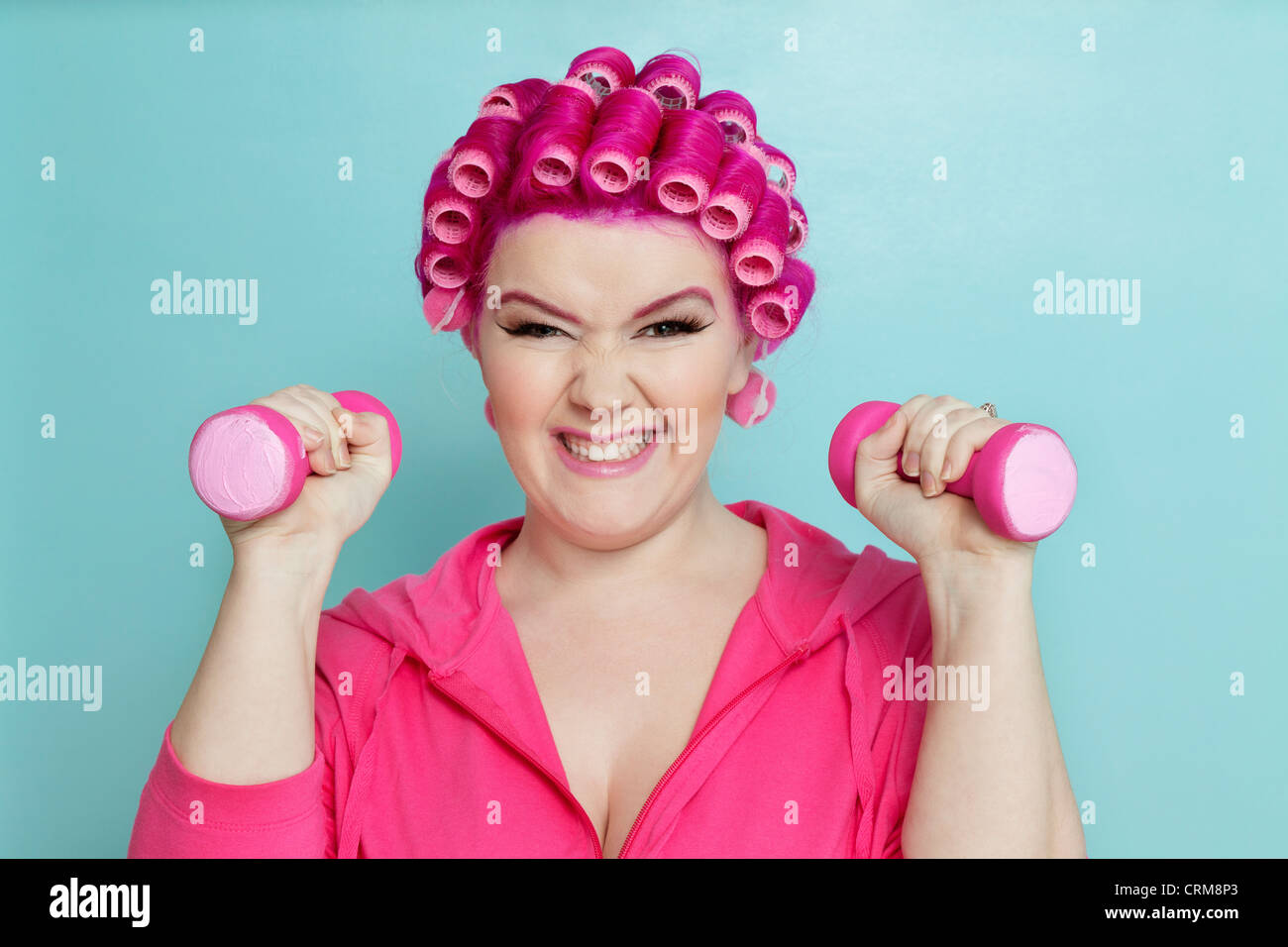 Portrait of a young woman happy with lifting weights Stock Photo - Alamy