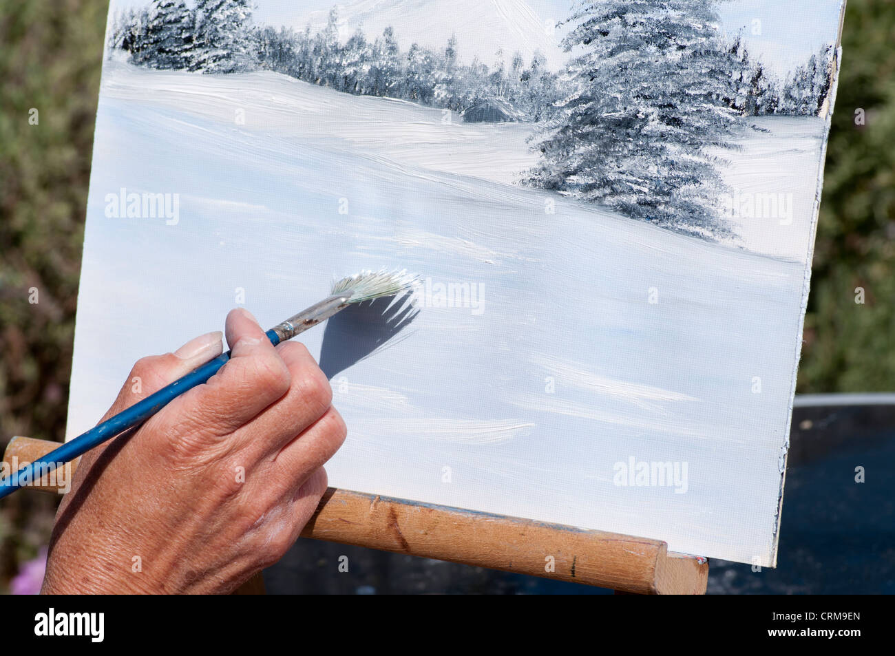 Person Artist Painting With Paint Brush On A Canvas On An Easel Stock ...