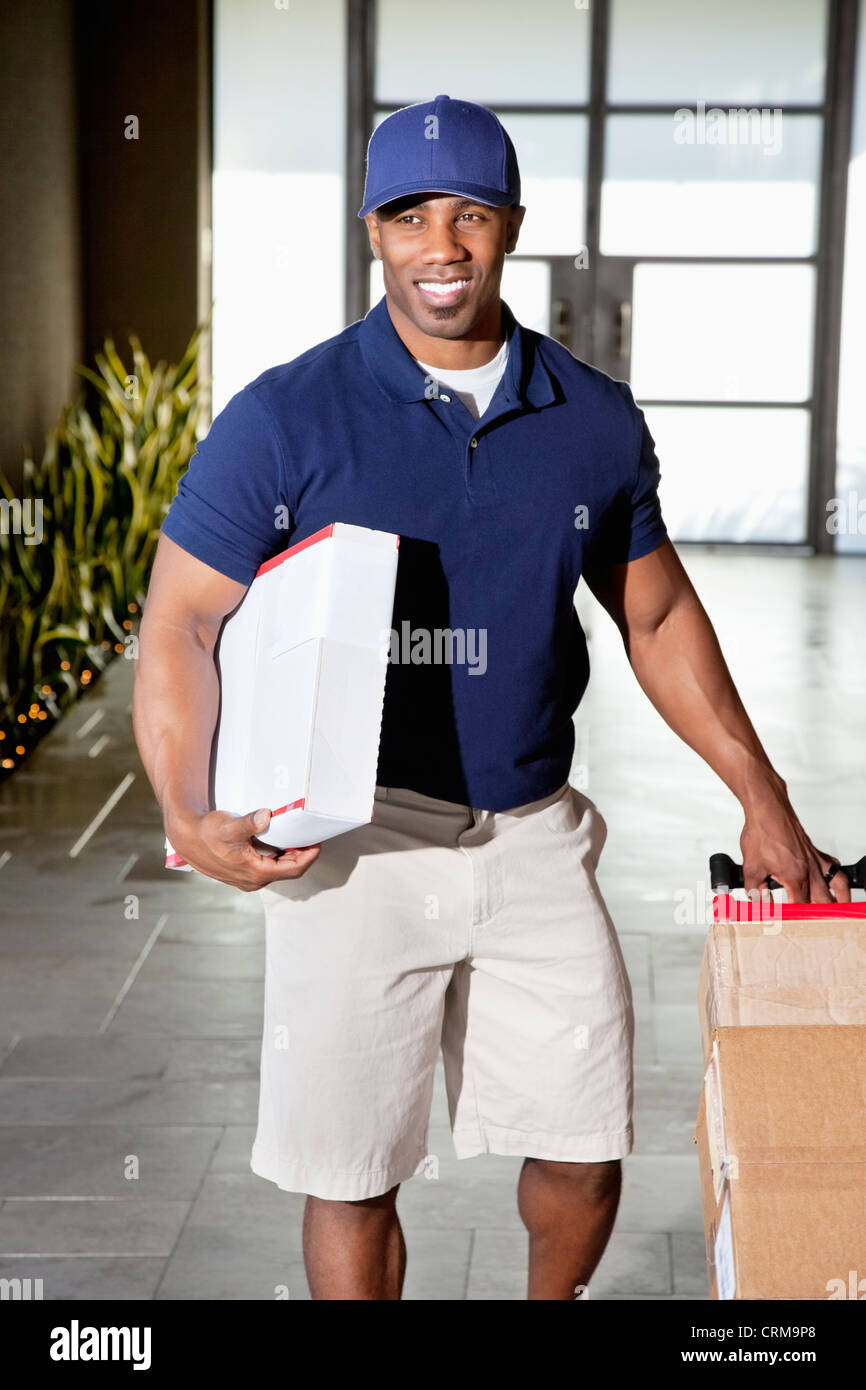 African American man carrying boxes for delivery Stock Photo - Alamy