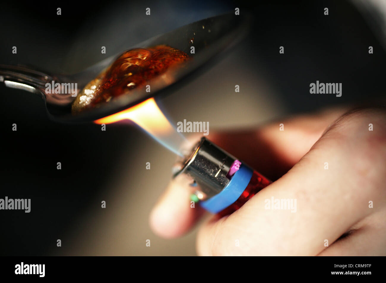 man cooking up drugs on a spoon with a lighter Stock Photo - Alamy