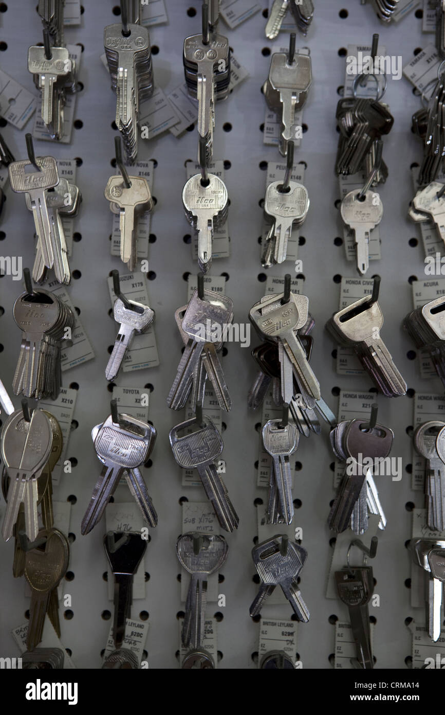 Large group of keys hanging on hooks in store Stock Photo - Alamy