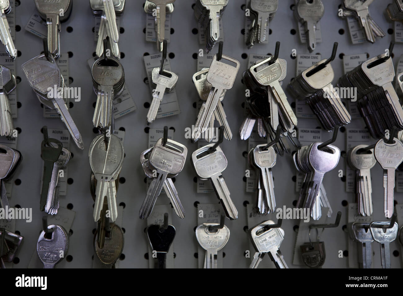 Keys hanging on hooks in store Stock Photo - Alamy