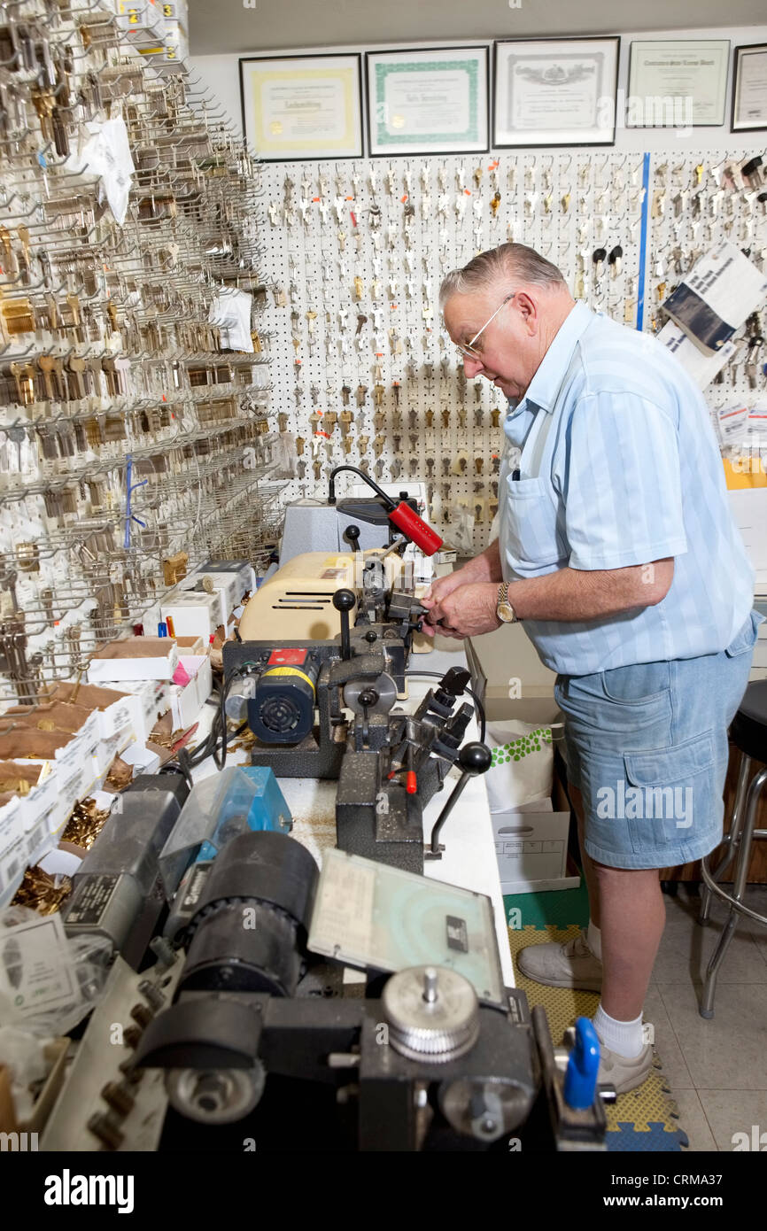 Side view of senior locksmith working in store Stock Photo - Alamy