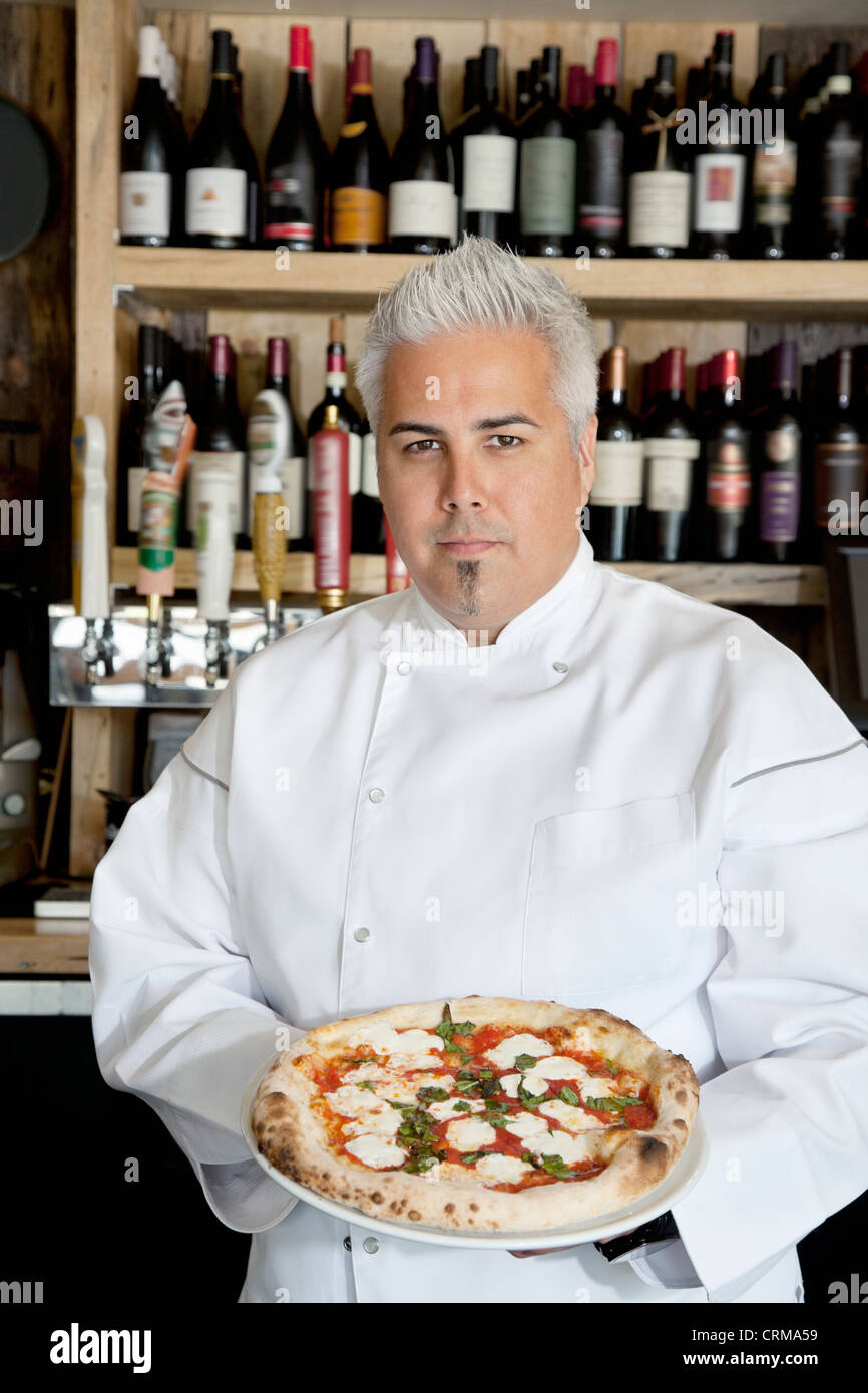 Portrait of a confident chef with pizza Stock Photo - Alamy