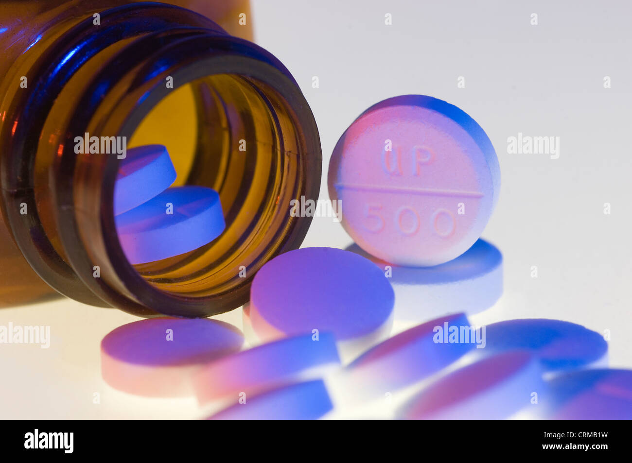 White tablets spill from a medicine bottle Stock Photo - Alamy