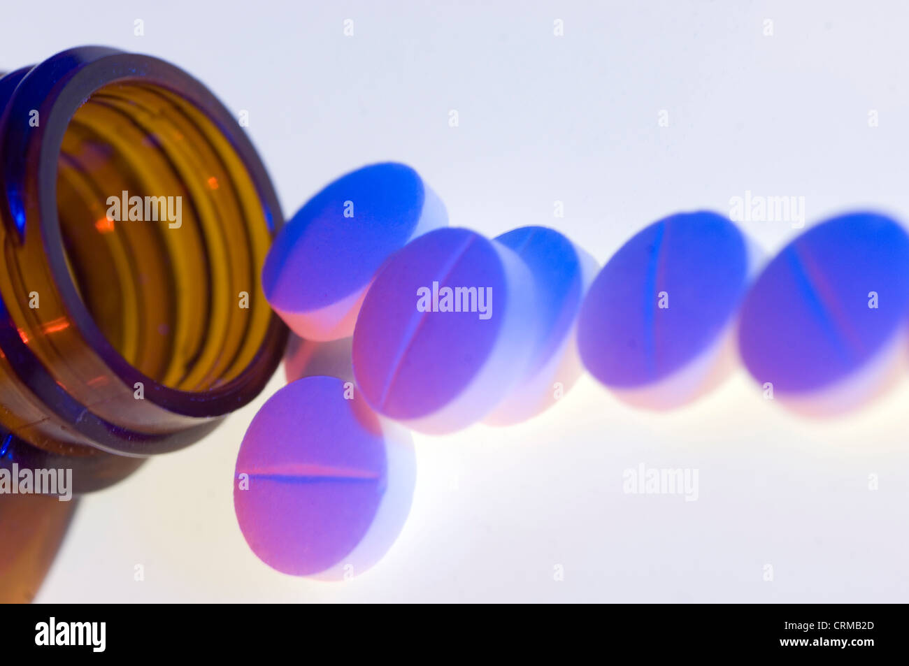 White tablets spill from a medicine bottle Stock Photo - Alamy