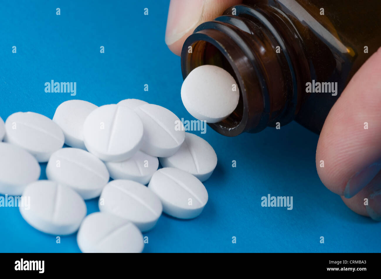 Pouring out pills from the bottle Stock Photo - Alamy
