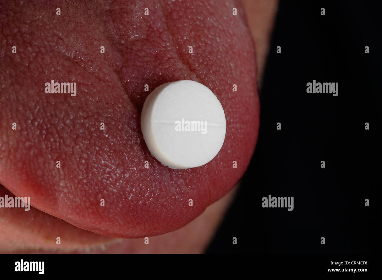 A man is taking a medication tablet Stock Photo - Alamy