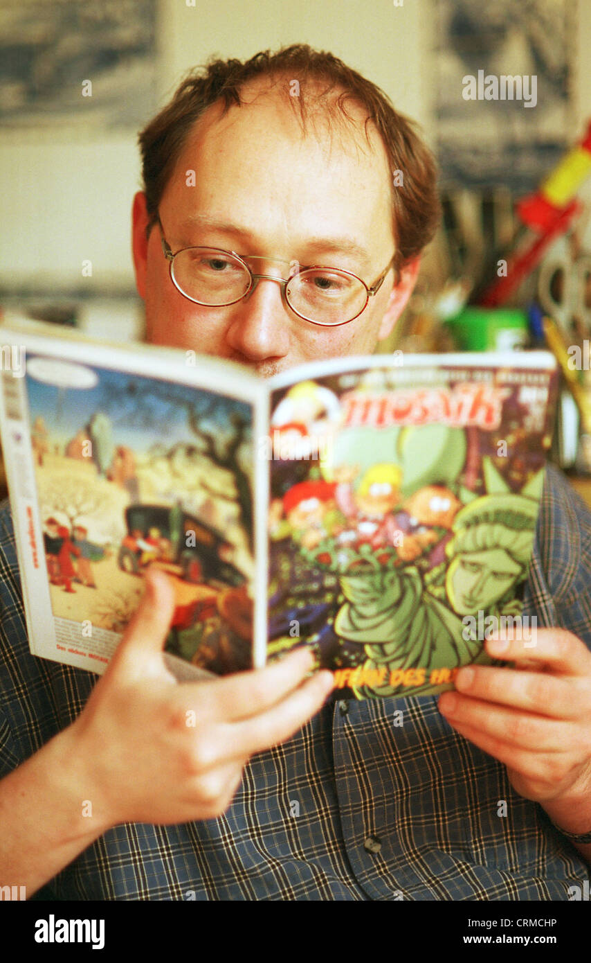 Comic Artist at Mosaic Verlag in Berlin reads comics Stock Photo - Alamy
