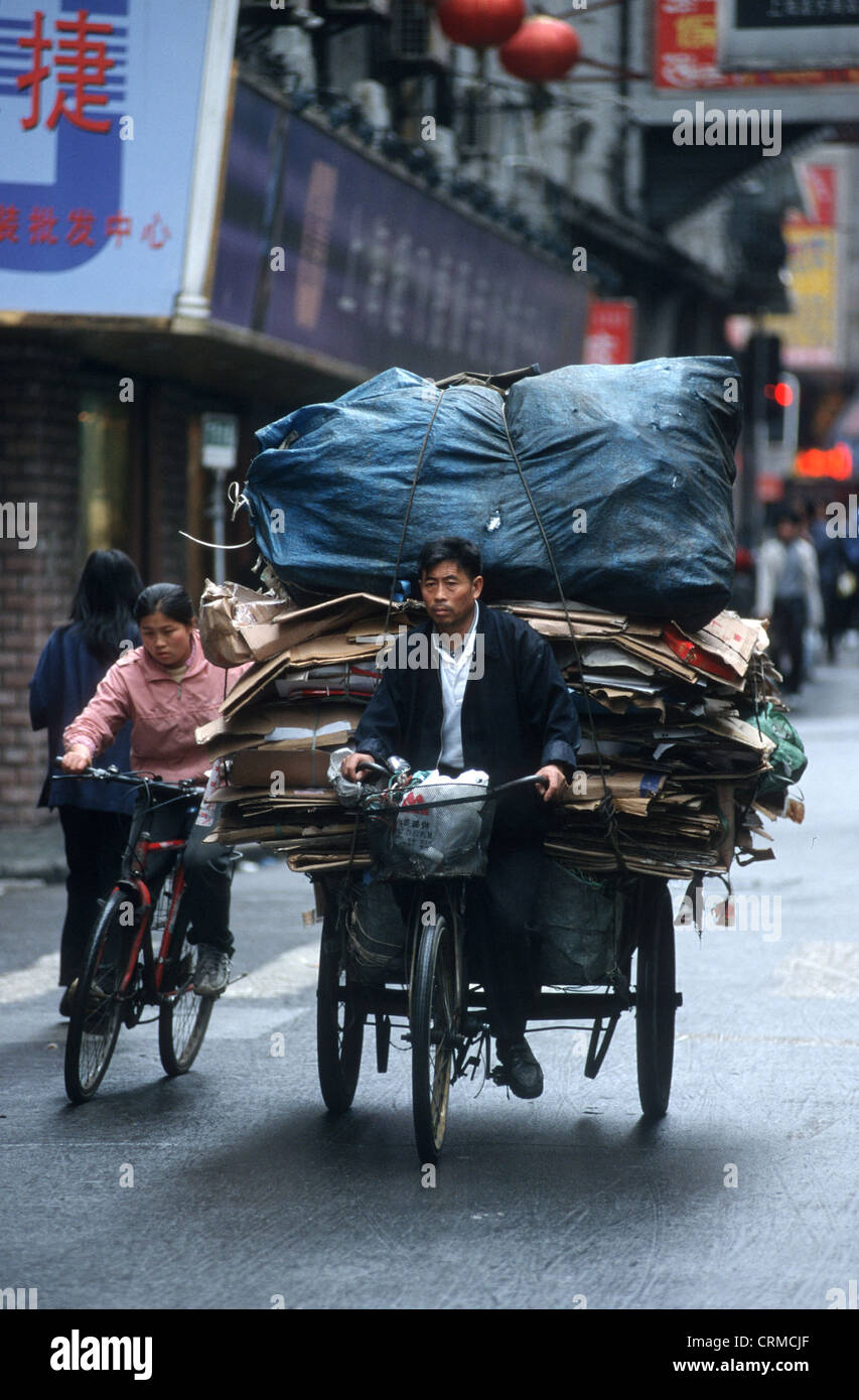 Heavy Loaded cyclists in Shanghai Center Stock Photo - Alamy