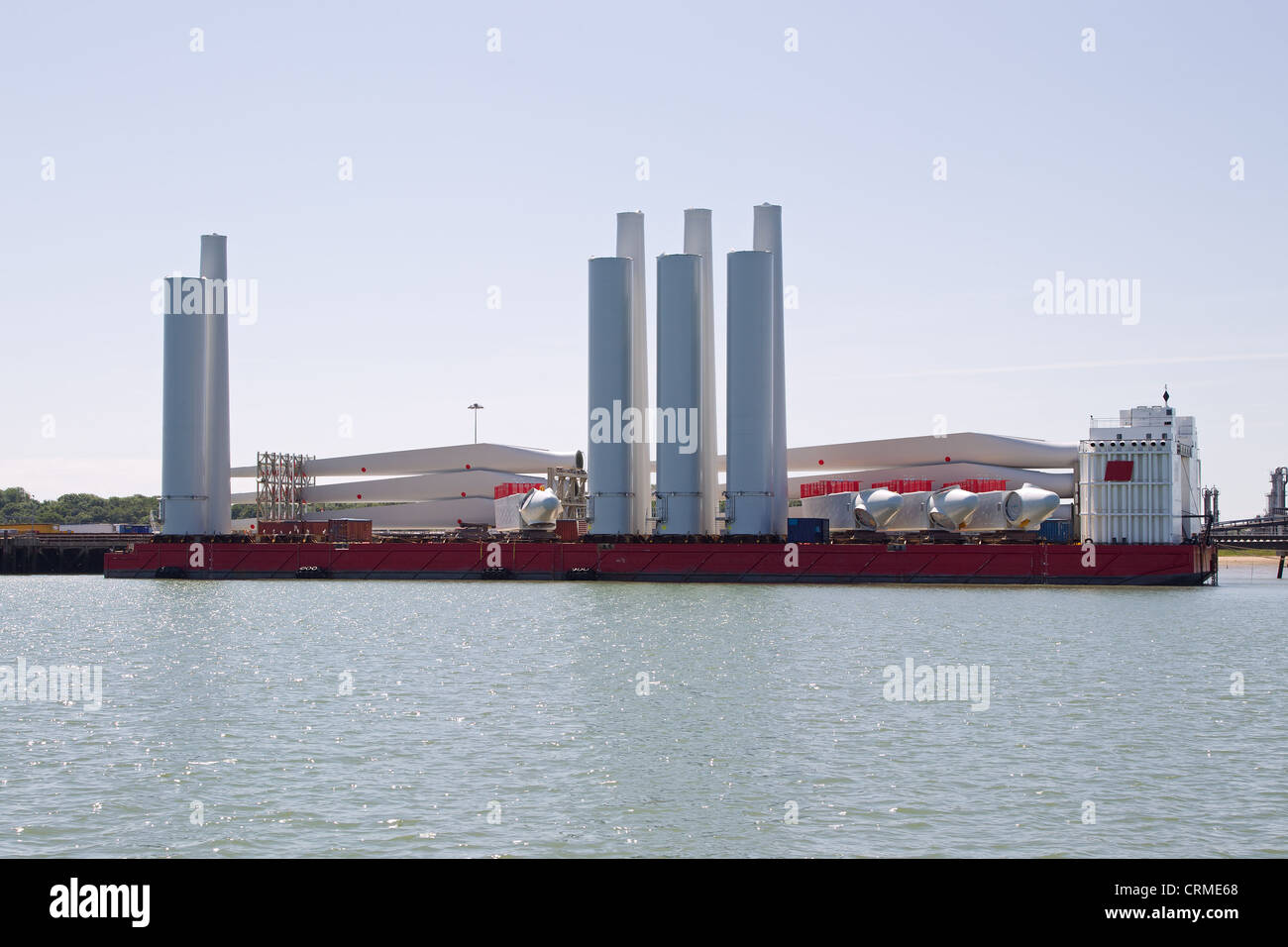 A semi-submersible barge loaded with wind farm turbines,in harbour in ...