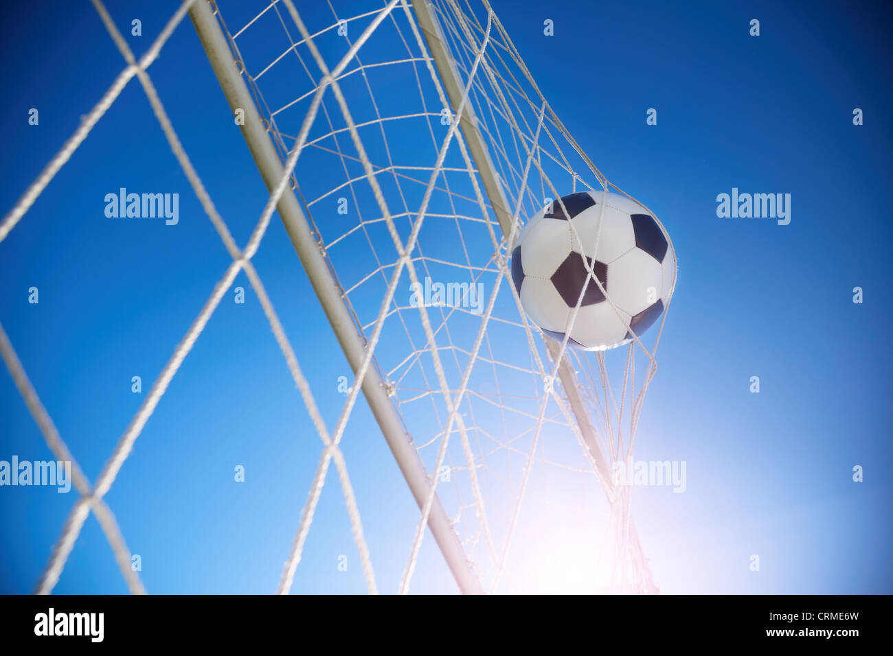 Soccer ball going into goal net Stock Photo - Alamy