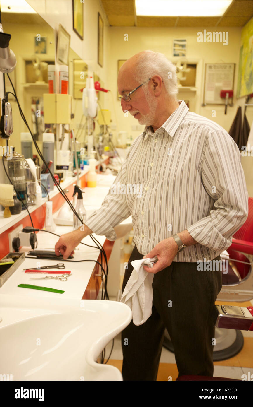 Side view of a senior barber in shop Stock Photo - Alamy