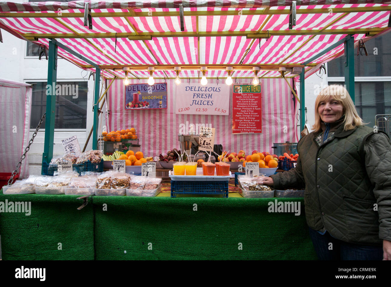 Portrait of a happy senior fruit stall owner standing in market Stock ...