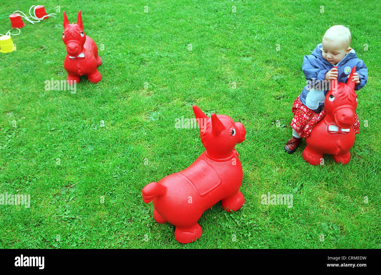 Toddler plays (14 months) with Huepfepferd Stock Photo - Alamy