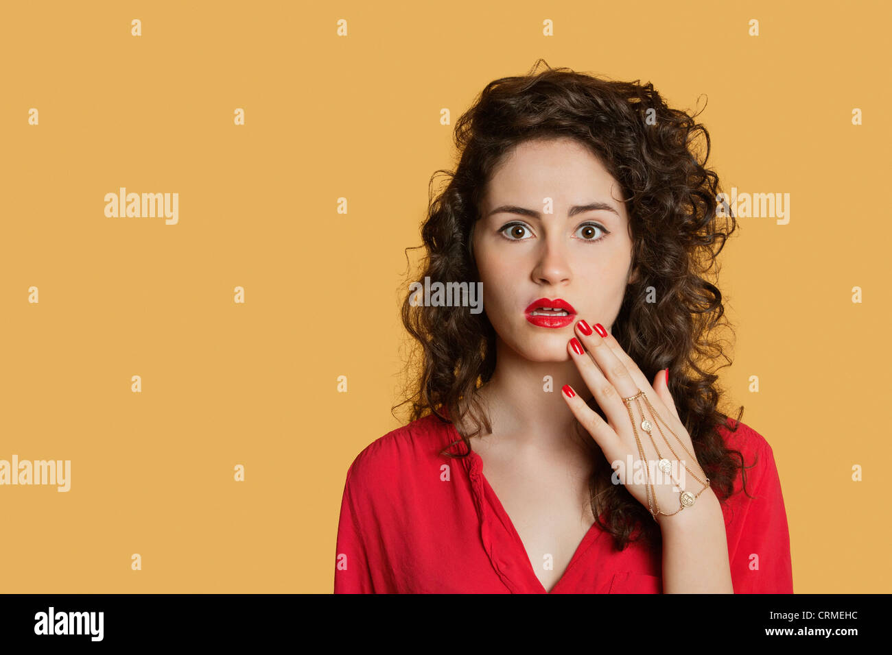 Portrait of a shocked woman over colored background Stock Photo - Alamy