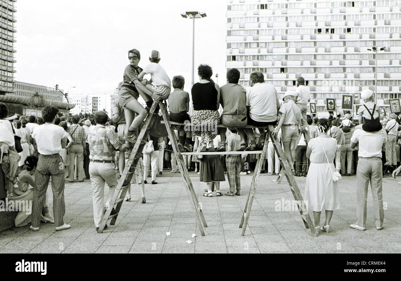 Spectators at May Day rally, East Berlin 1985 Stock Photo - Alamy