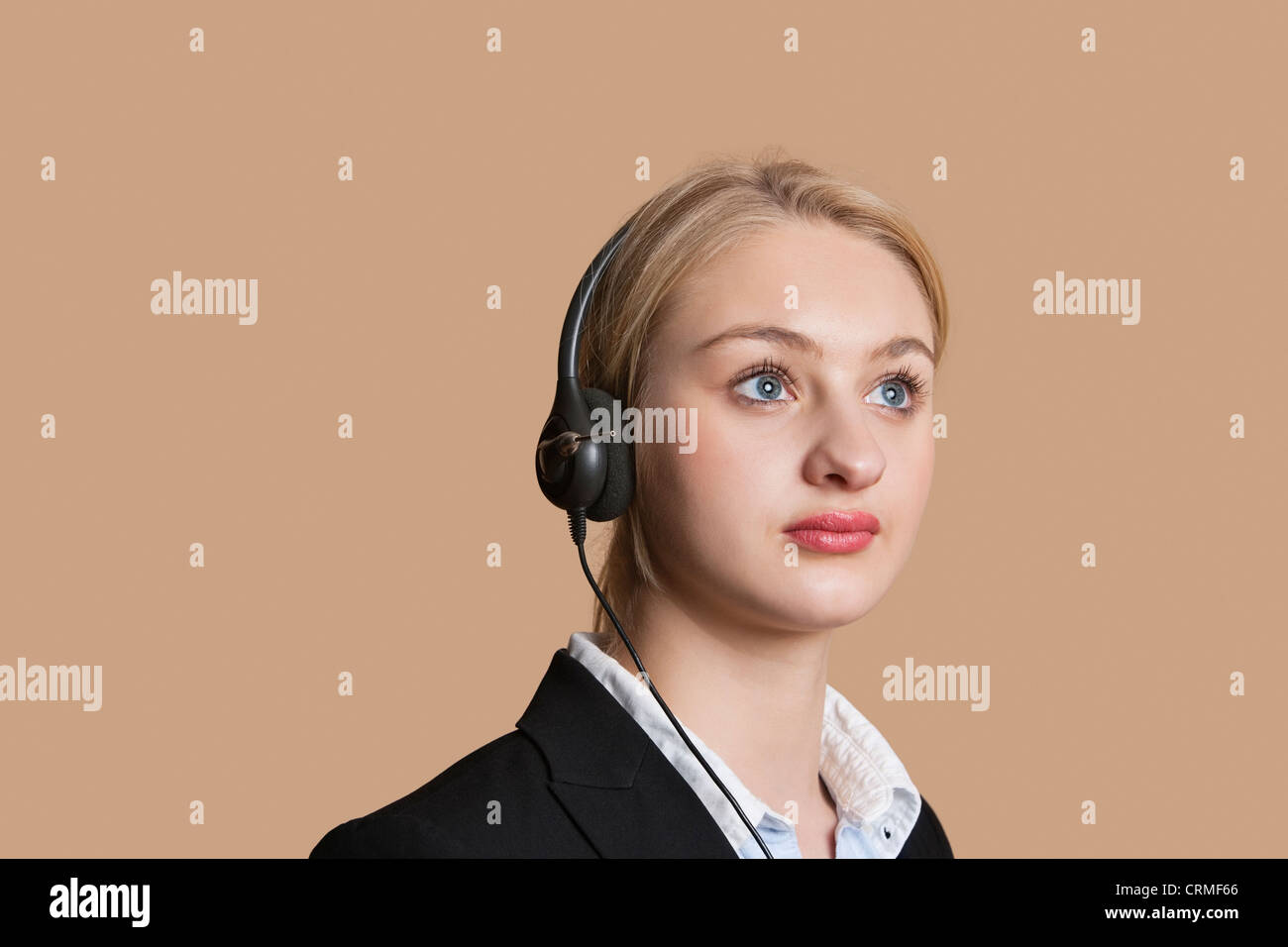 Beautiful female customer service representative over colored ...