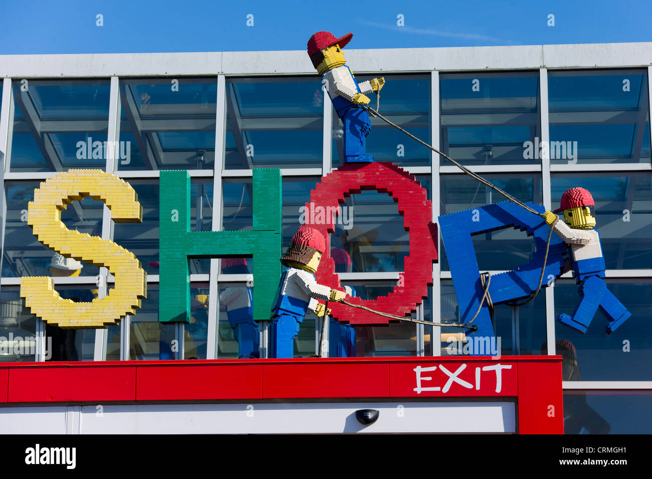 Lego figures climbing on the sign of the Lego Shop, Legoland, Billund ...