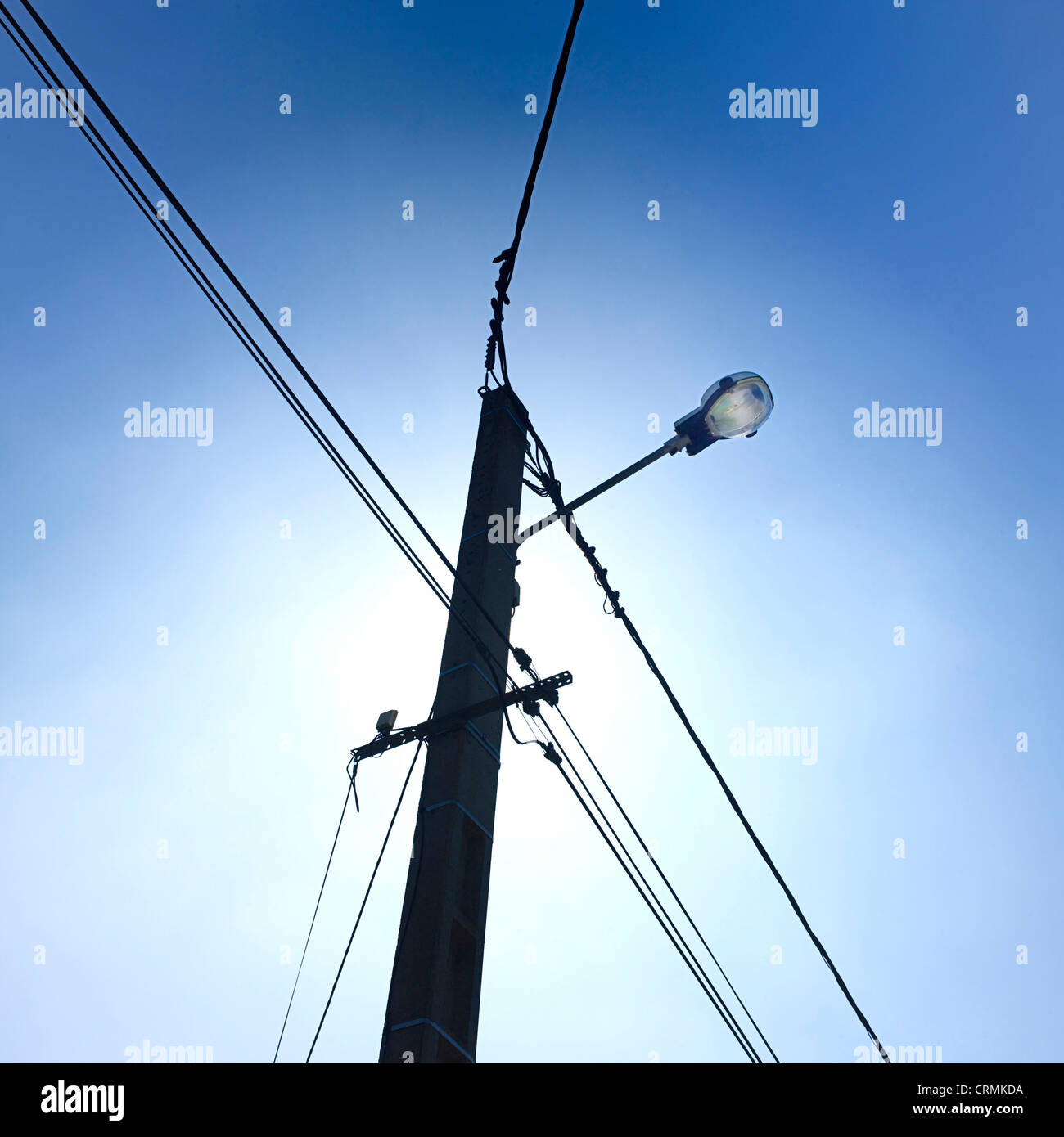 Utility pole with street light and wires during clear daytime sky Stock ...
