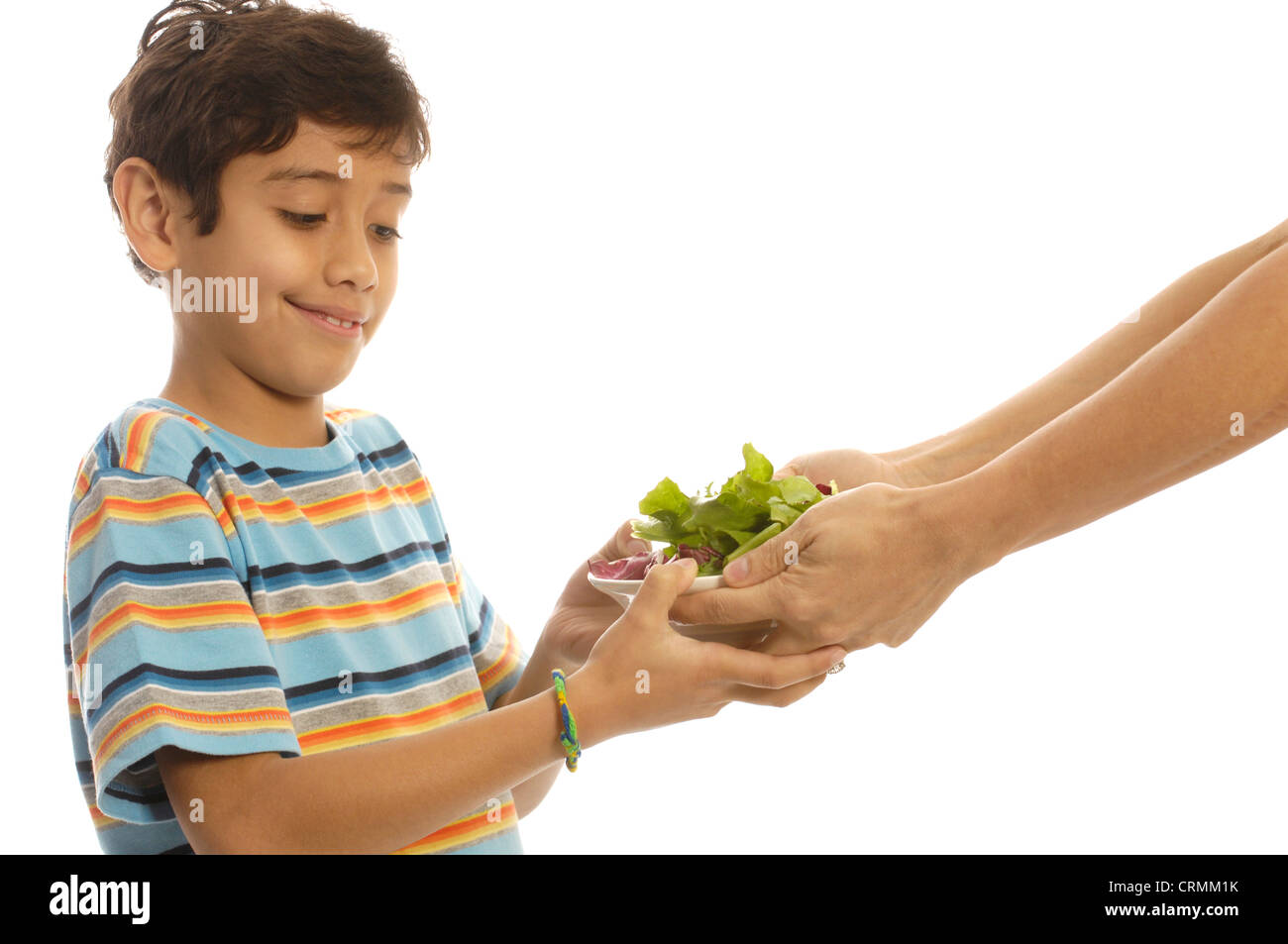 A young boy accepting a bowl of salad from his mother Stock Photo - Alamy
