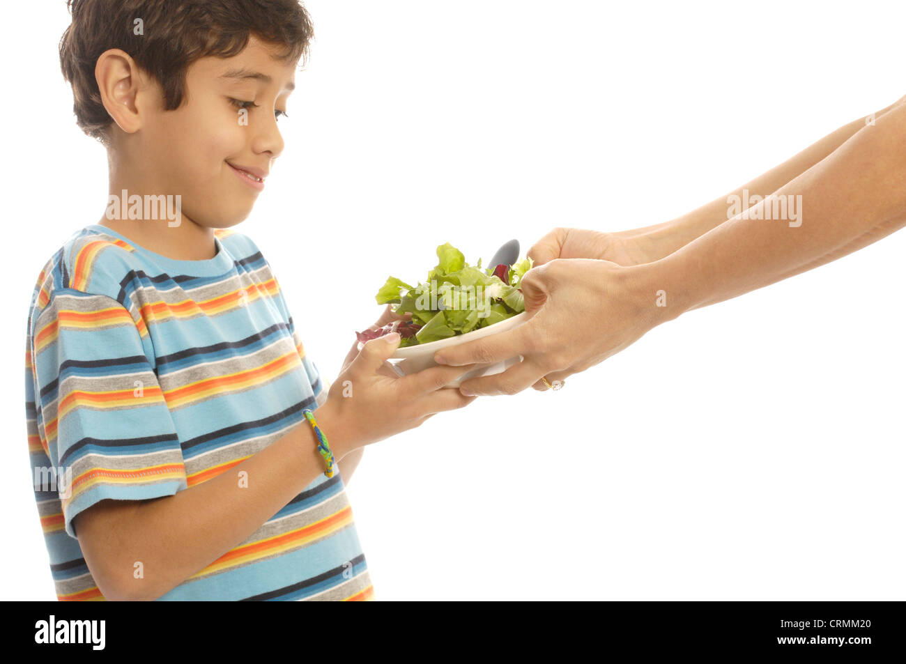 A young boy accepting a bowl of salad from his mother Stock Photo - Alamy