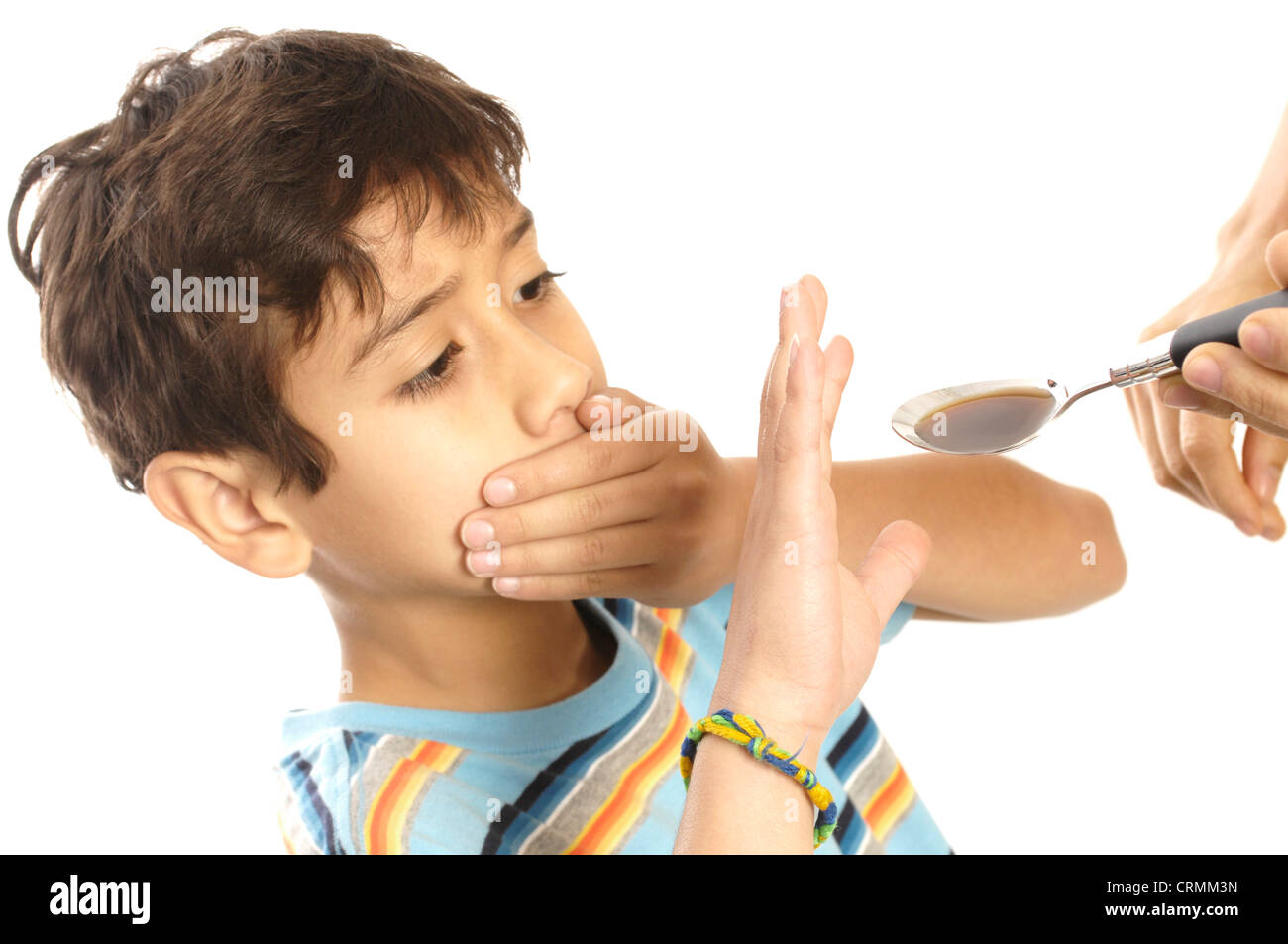 A young boy refusing to take cough syrup from his mother Stock Photo ...