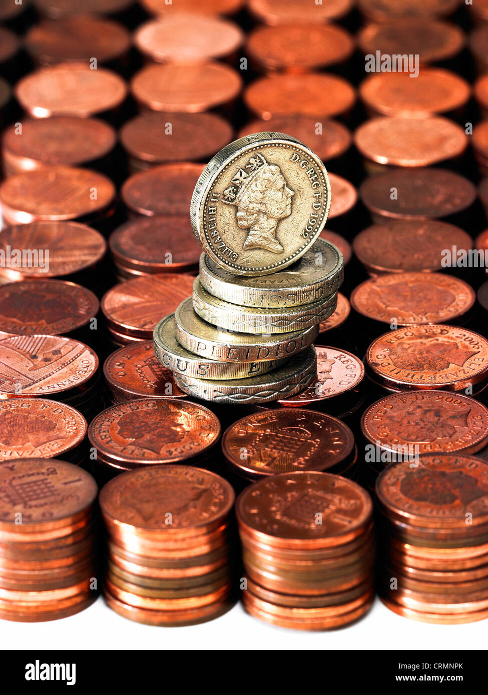 Neat piles of British pennies with a pile of one pound coins Stock ...