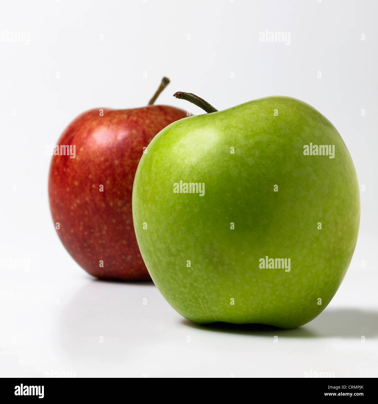 A red apple with a green apple in the background Stock Photo - Alamy