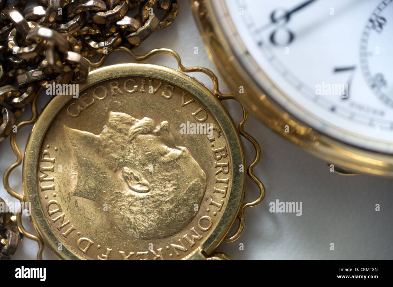 A gold pocket watch with Arabic numerals seconds dial and intricate ...