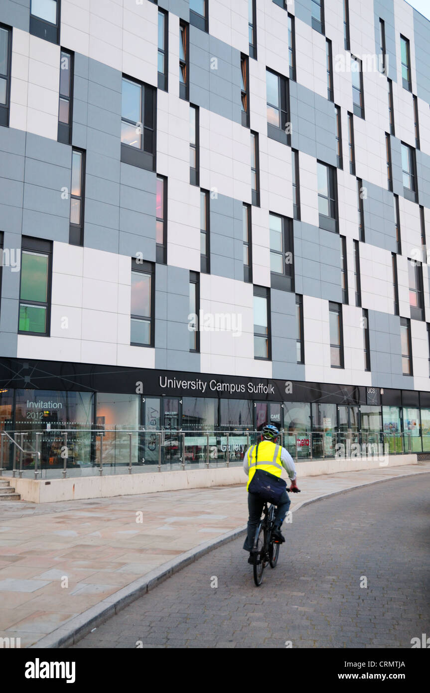 Cyclist passing by the University Campus Suffolk building, Neptune ...