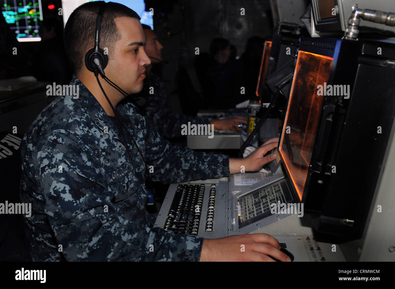 Operations Specialist 3rd Class Michael Caudill watches a radar screen ...