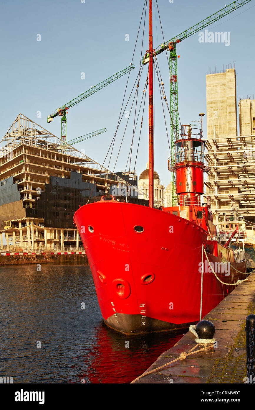Red ship moored in the docks at Liverpool surrounded by new ...