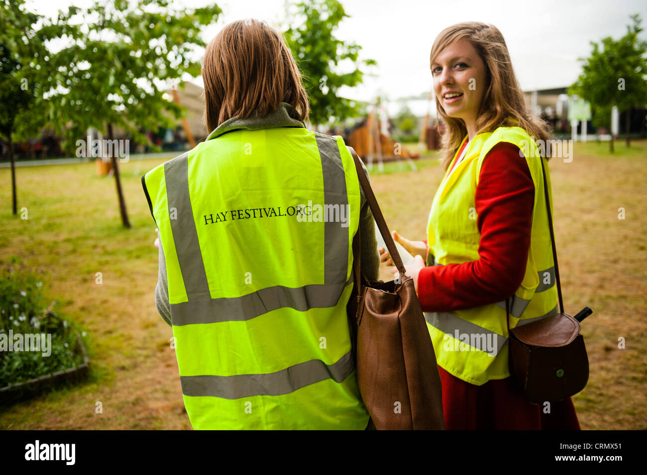 Two girls volunteers helpers wearing hi-vis high visibility tabards at ...
