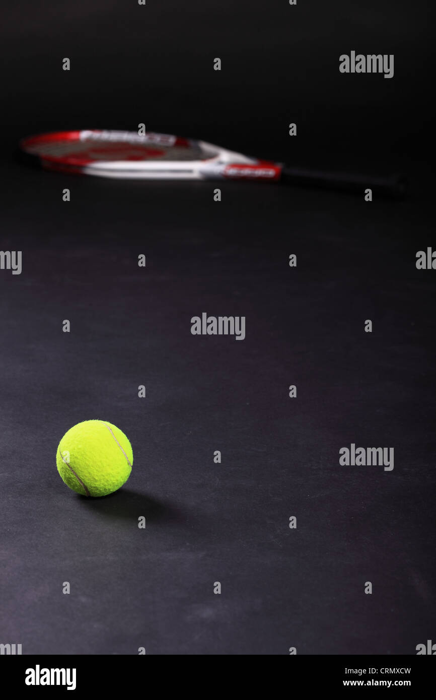 tennis racket and ball on black background studio shot Stock Photo - Alamy