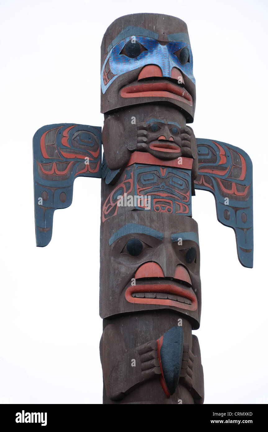 Totem pole faces on a white background. A symbol representing a family ...