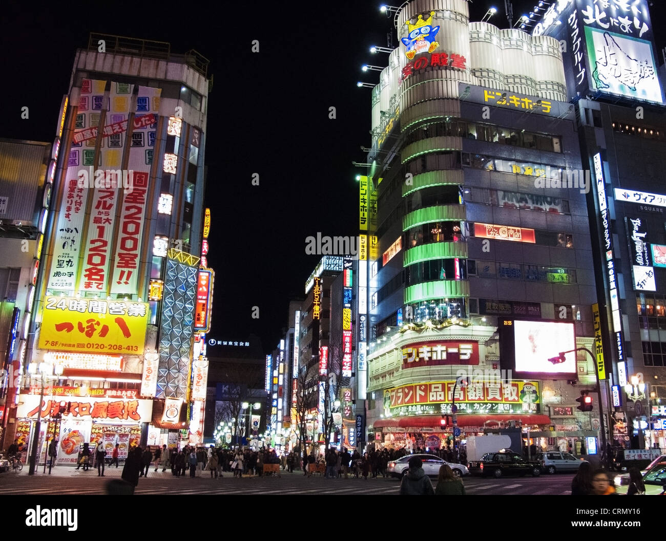 Night scene of neon covered buildings in the Shinjuku district of Tokyo ...