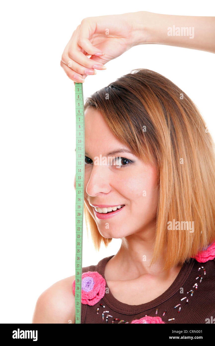 Beautiful young caucasian woman measuring her body with tape, isolated ...