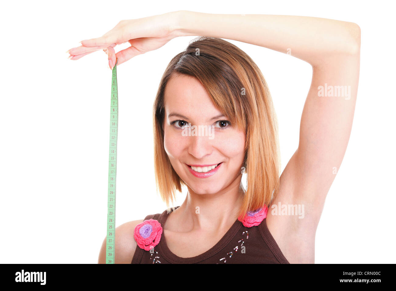 Beautiful young caucasian woman measuring her body with tape, isolated ...